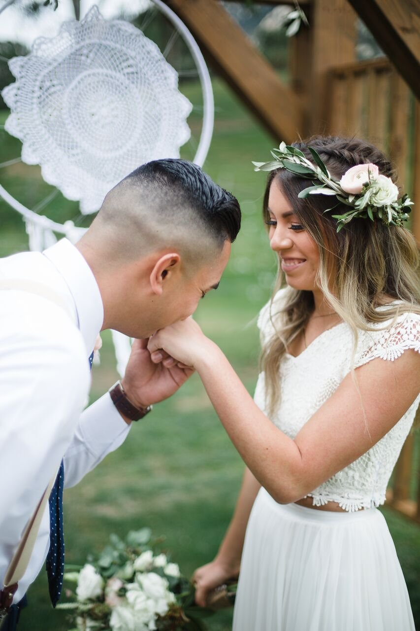 A romantic garden ceremony with a uniformed groom and boho bride ...