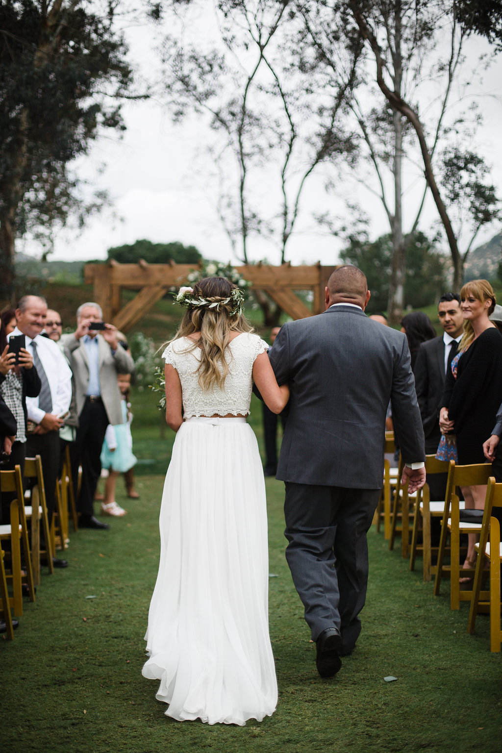 A romantic garden ceremony with a uniformed groom and boho bride ...