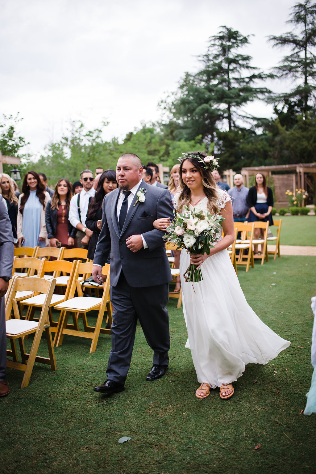 A romantic garden ceremony with a uniformed groom and boho bride ...