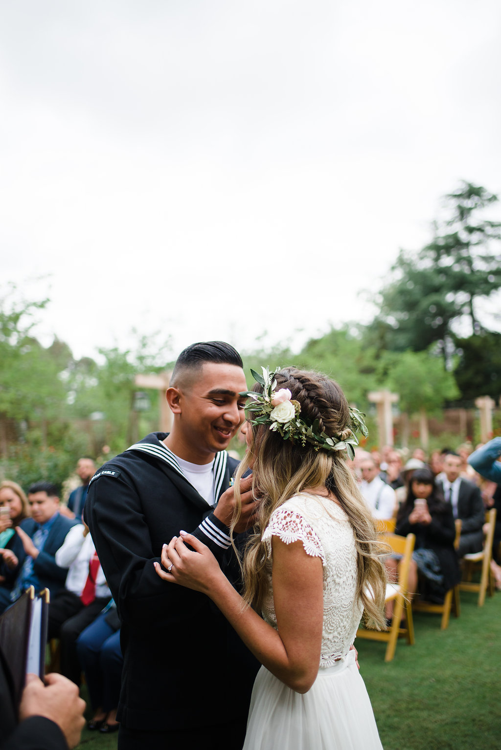 A romantic garden ceremony with a uniformed groom and boho bride ...
